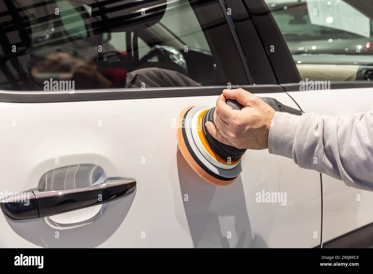 Master is polishing the car. Master mechanic removal of dents defects ...