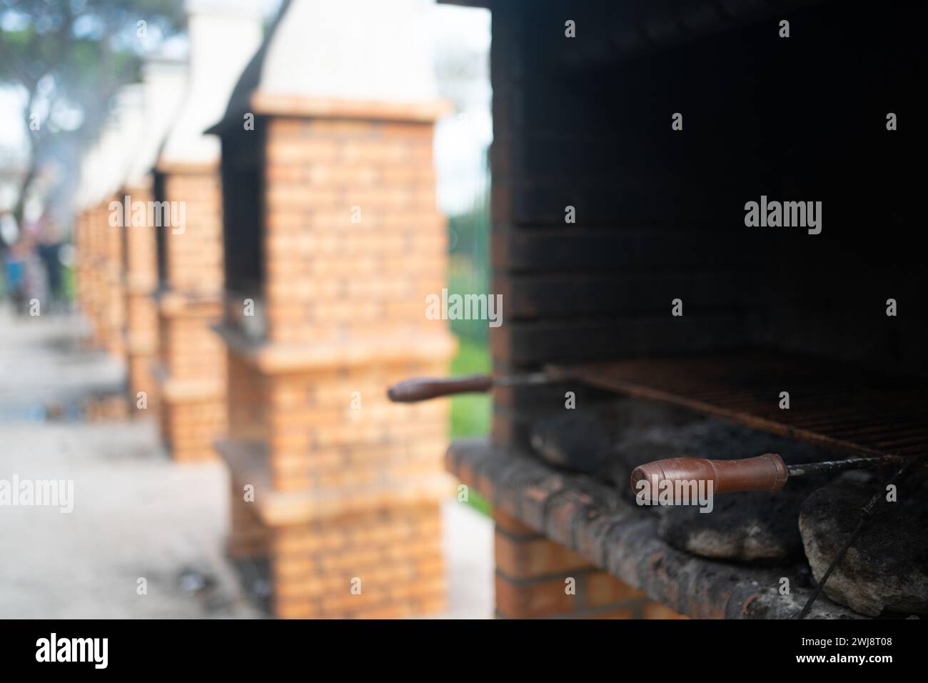 Outdoor BBQ for cooking in public park. Red brick barbecues consist of ...