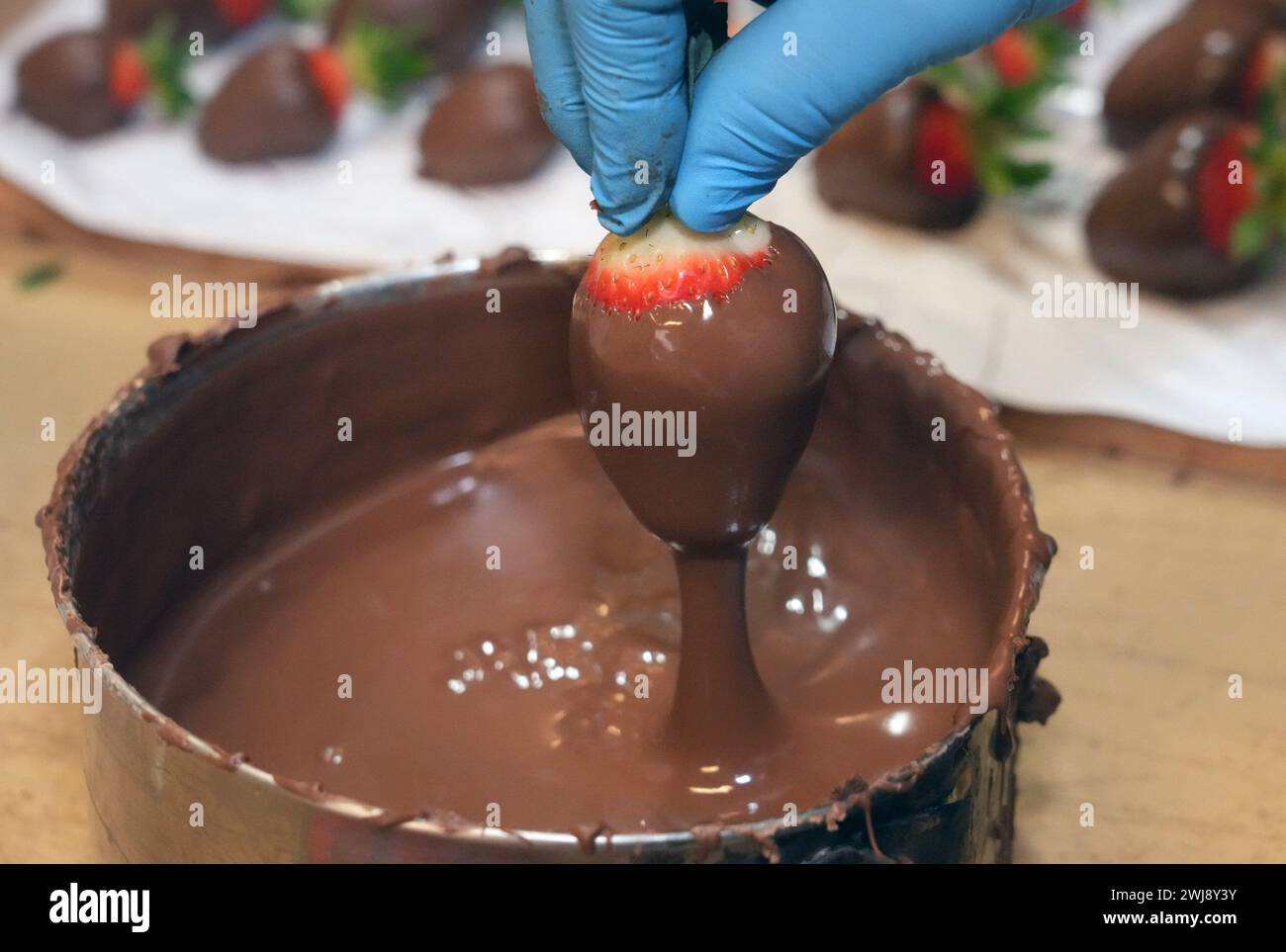 St. Louis, United States. 17th Feb, 2024. A strawberry is dipped into ...