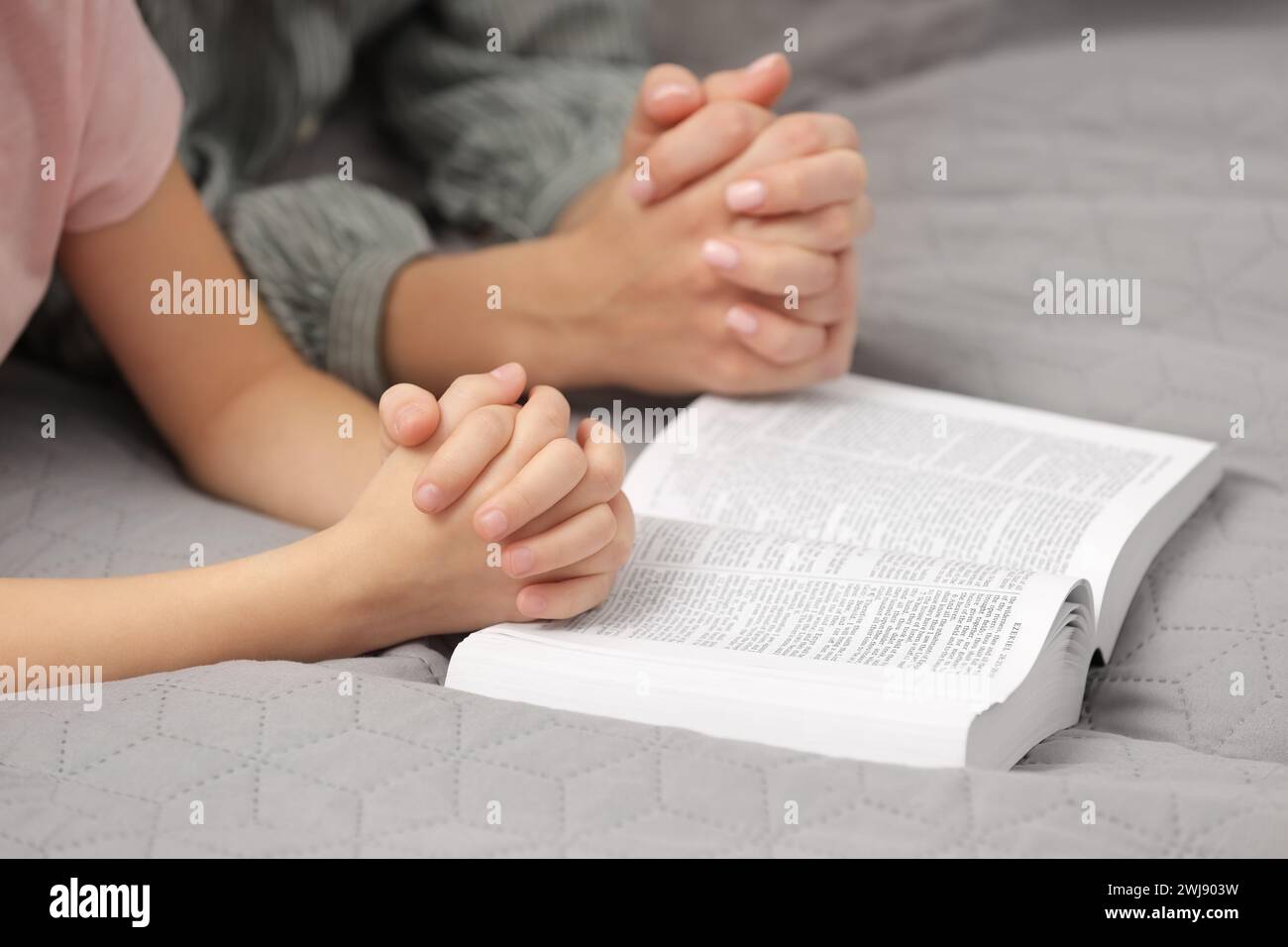 Girl reading bible in bed hi-res stock photography and images - Alamy