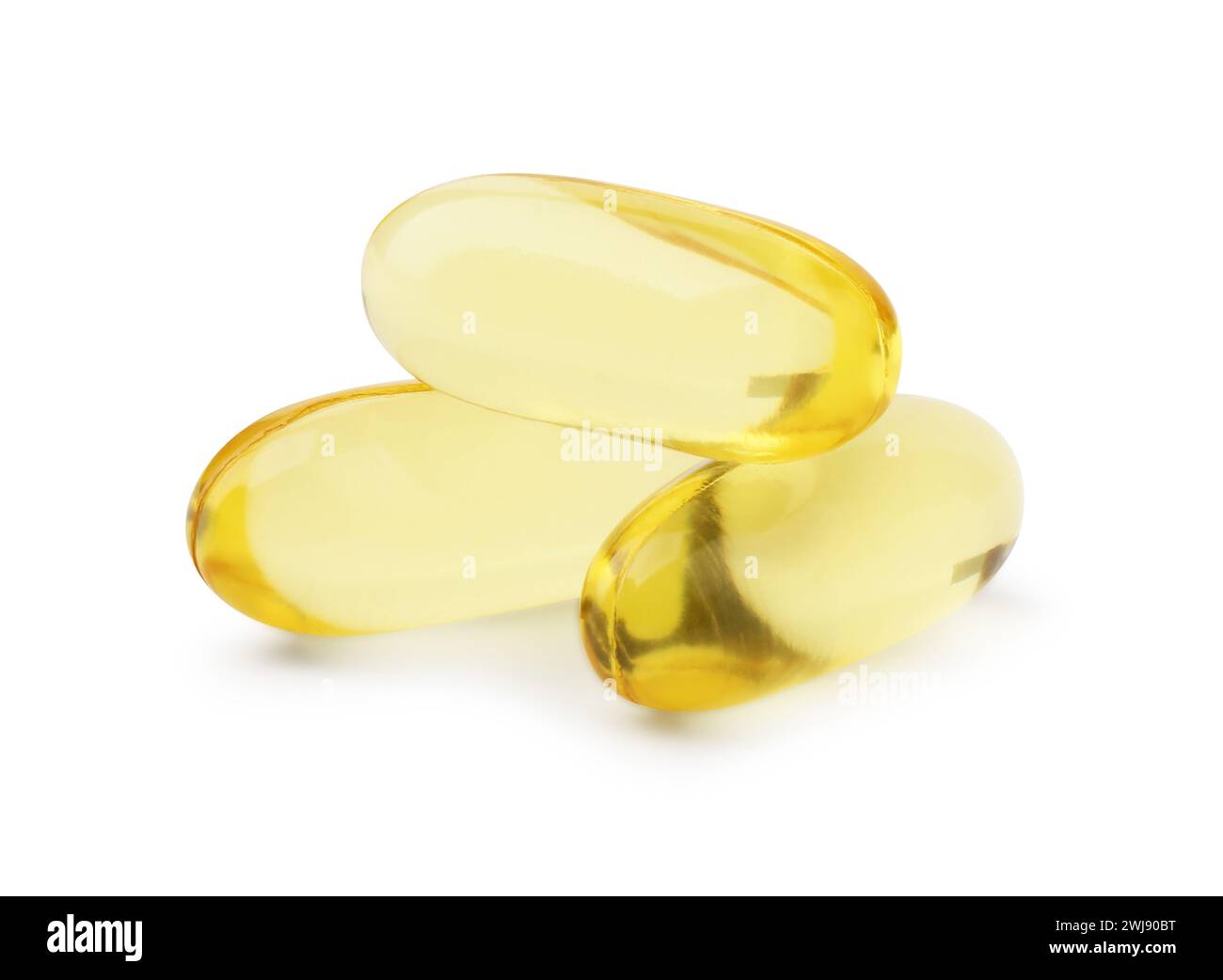 Many yellow vitamin capsules isolated on white Stock Photo - Alamy