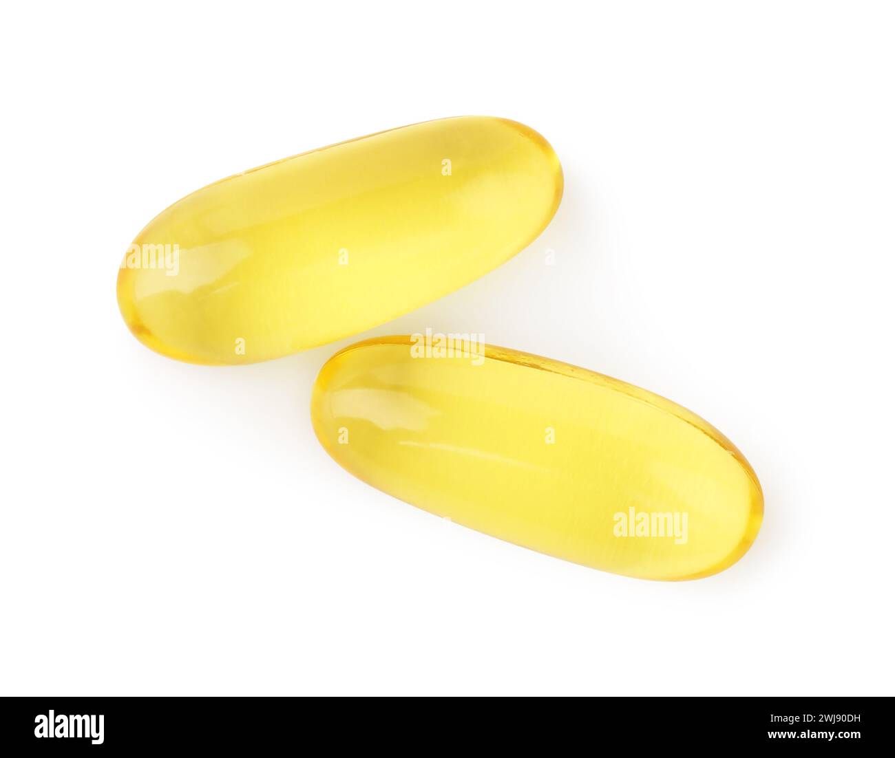 Yellow vitamin capsules isolated on white, top view Stock Photo - Alamy