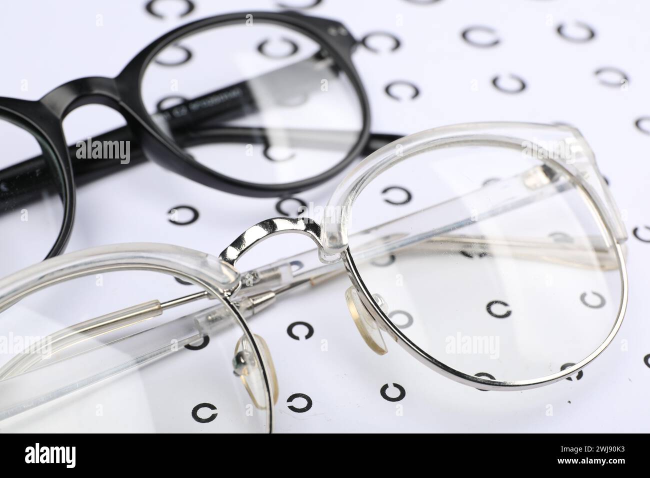 Vision test chart and different glasses, closeup Stock Photo - Alamy