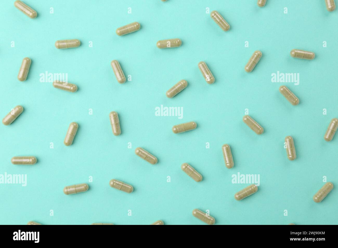 Many vitamin capsules on turquoise background, flat lay Stock Photo - Alamy