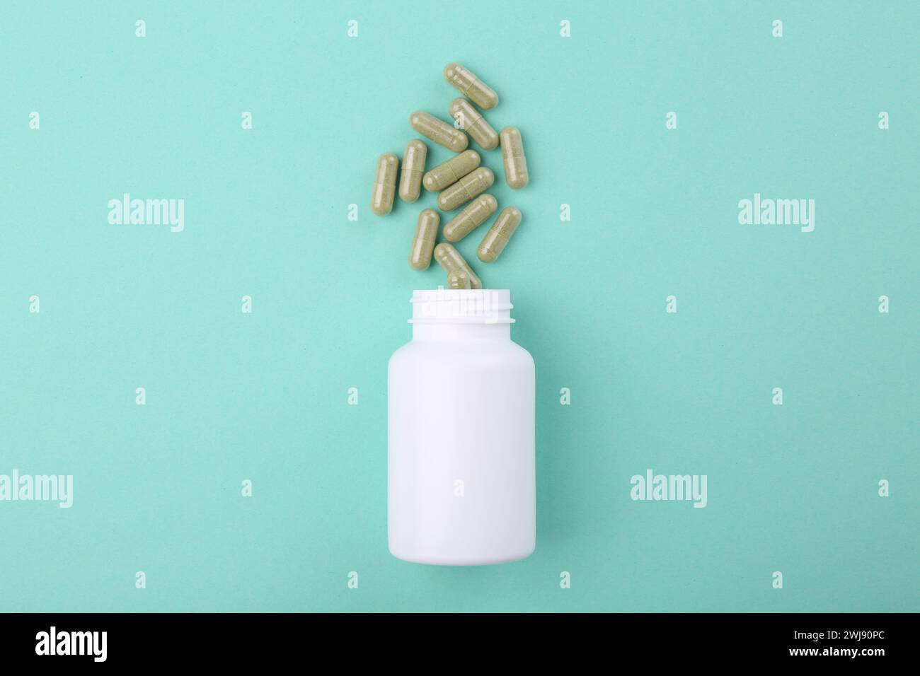 Bottle and vitamin capsules on turquoise background, top view Stock ...