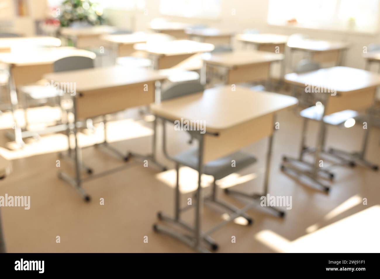 Blurred view of empty school classroom with desks and chairs Stock ...