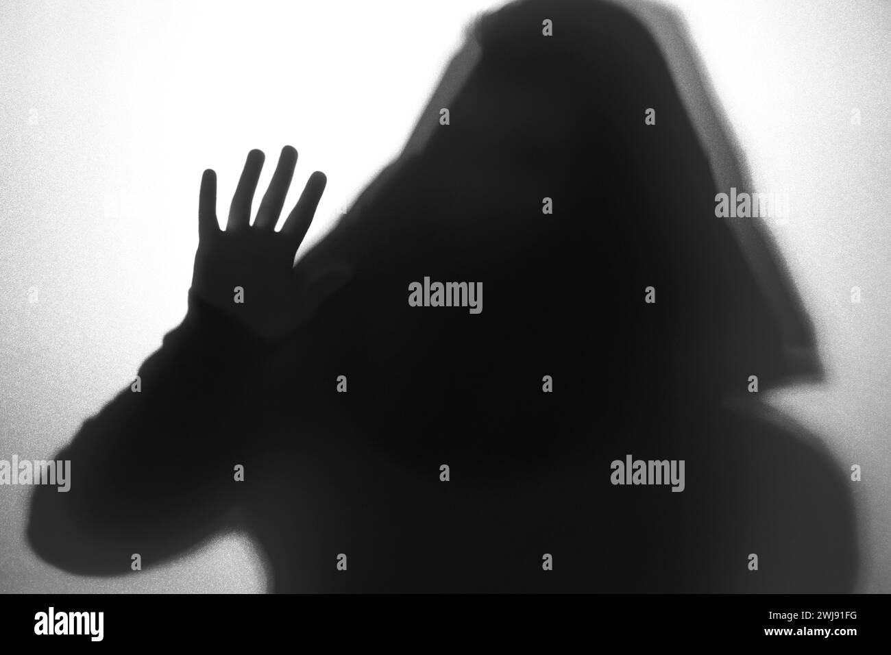 Silhouette of ghost behind glass against white background Stock Photo ...