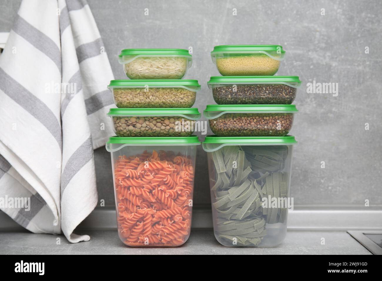 Plastic containers filled with food products on grey table Stock Photo ...