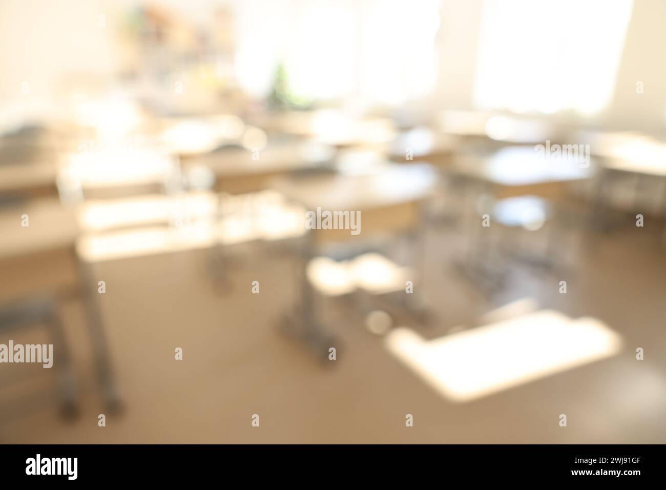 Blurred view of empty school classroom with desks and chairs Stock ...
