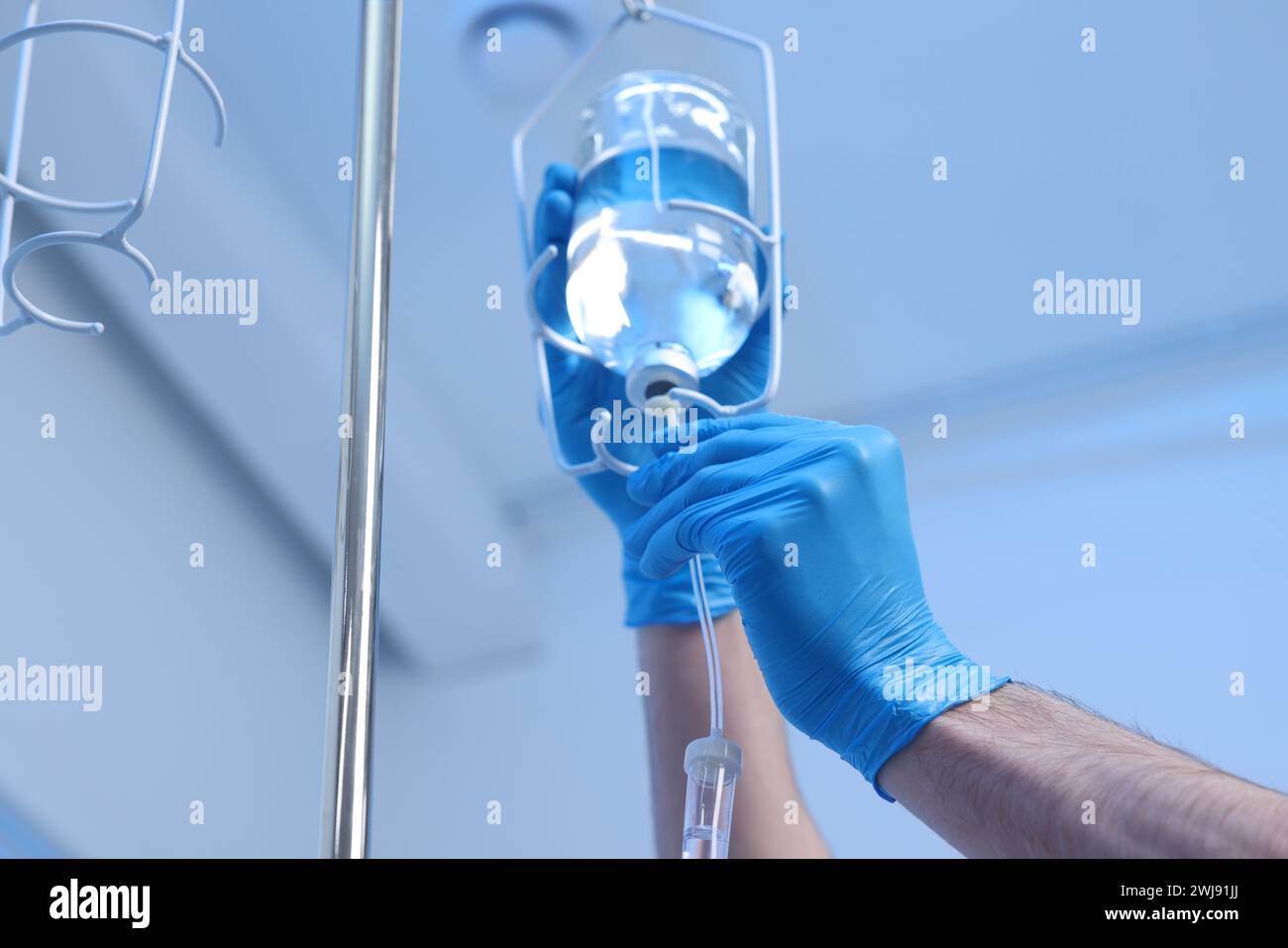Nurse setting up IV drip in hospital, closeup Stock Photo - Alamy