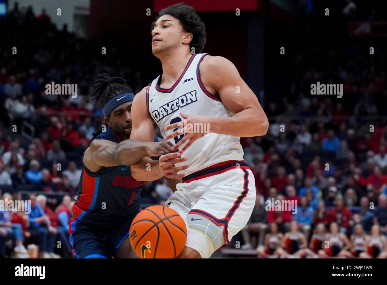 Duquesne guard Jimmy Clark III, back, knocks the ball away from Dayton ...
