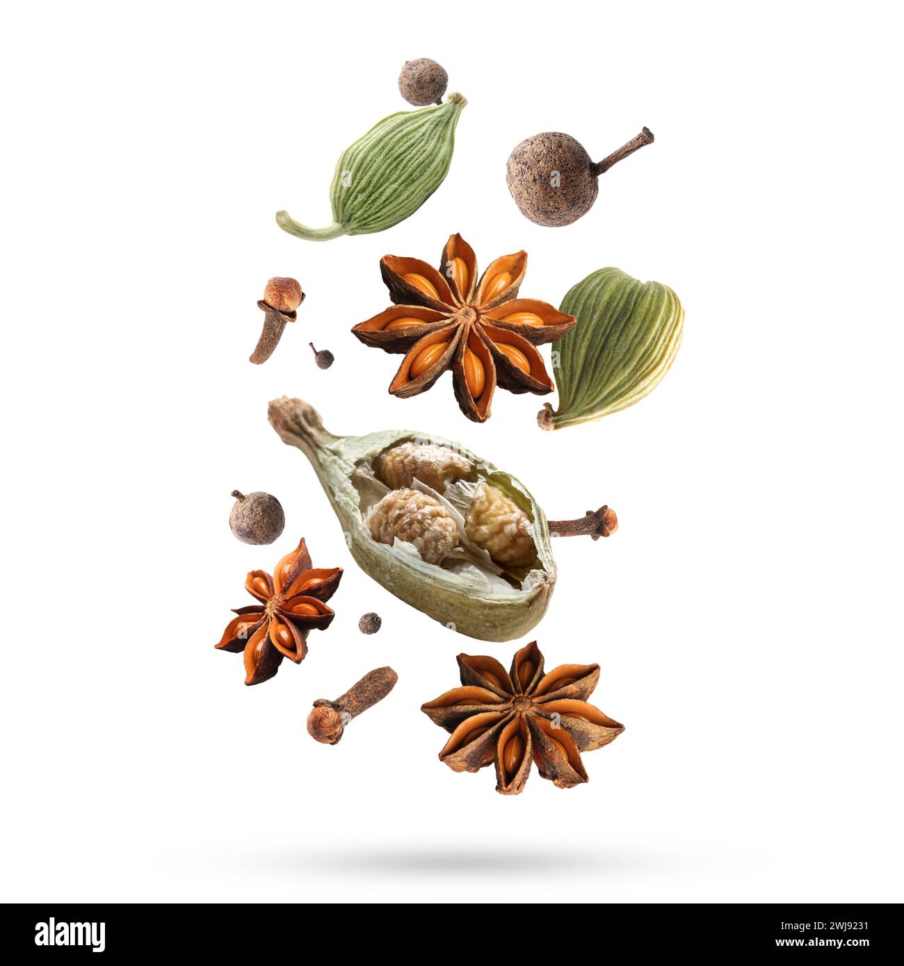 Different aromatic spices falling on white background Stock Photo - Alamy