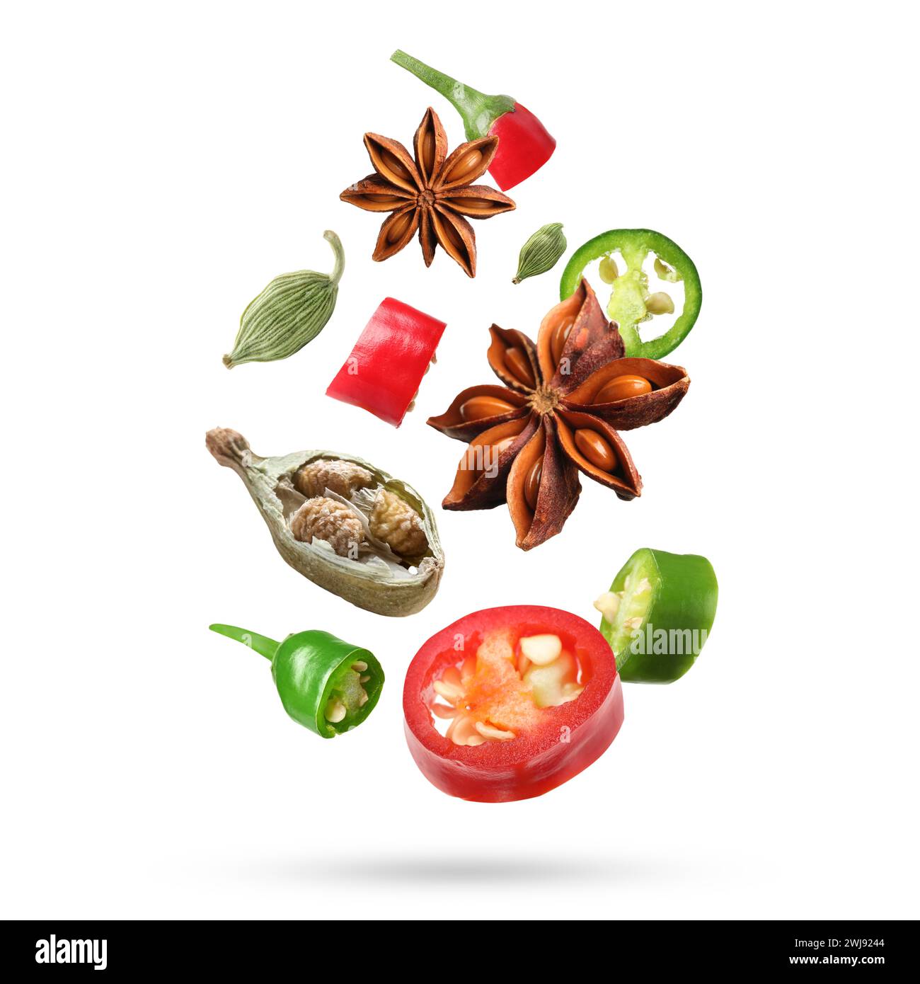 Different aromatic spices falling on white background Stock Photo - Alamy