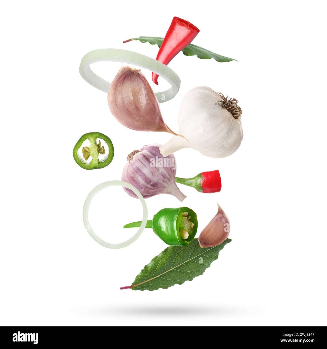 Different aromatic spices falling on white background Stock Photo - Alamy