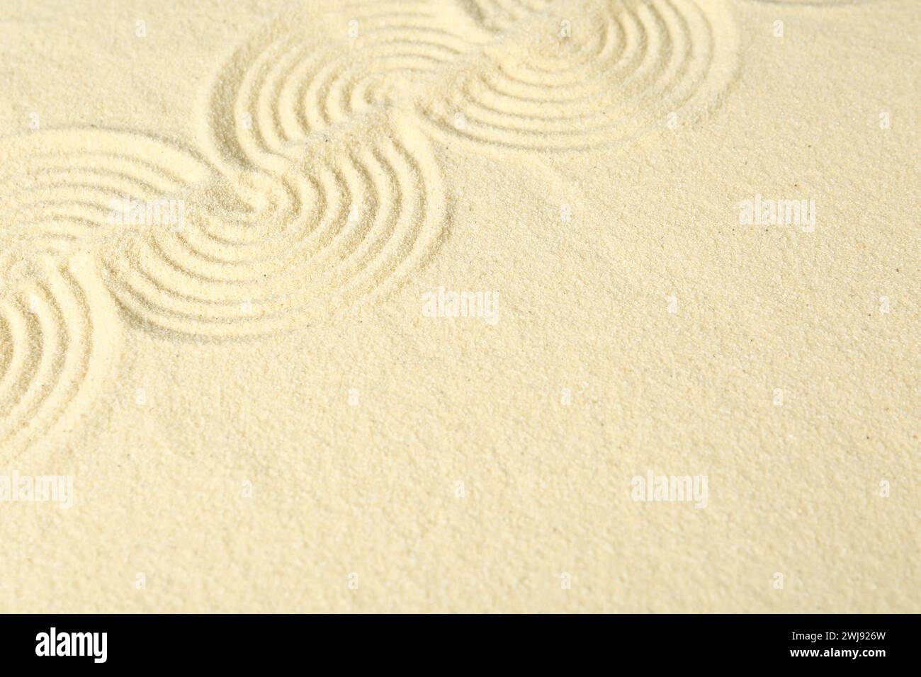 Zen rock garden. Wave pattern on beige sand Stock Photo - Alamy
