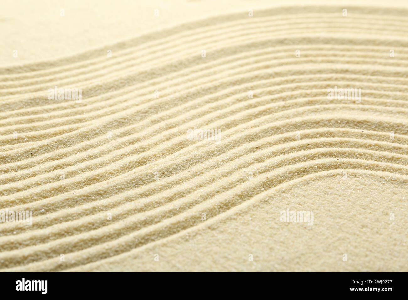 Zen rock garden. Wave pattern on beige sand Stock Photo - Alamy