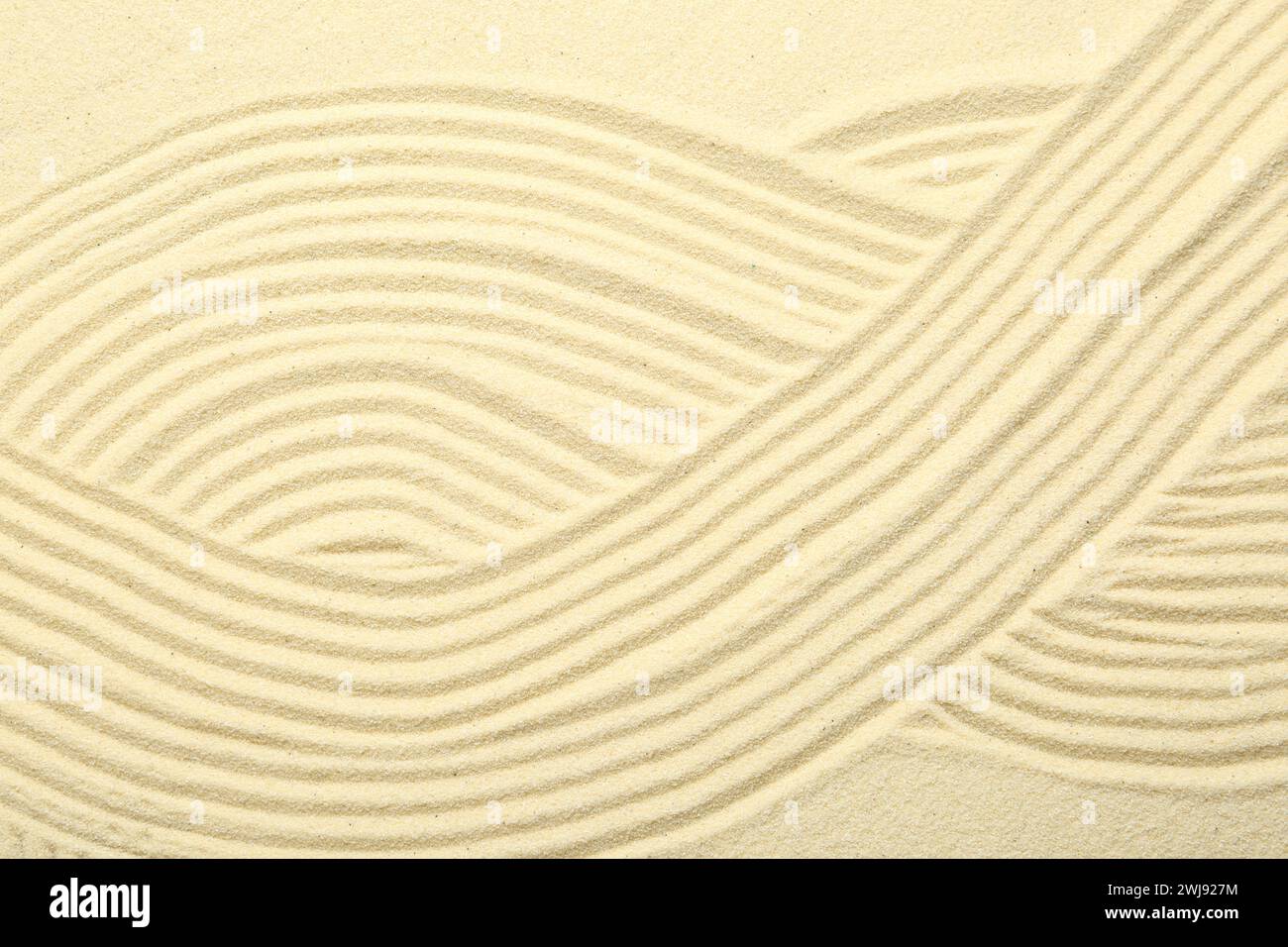 Zen rock garden. Wave pattern on beige sand, top view Stock Photo - Alamy