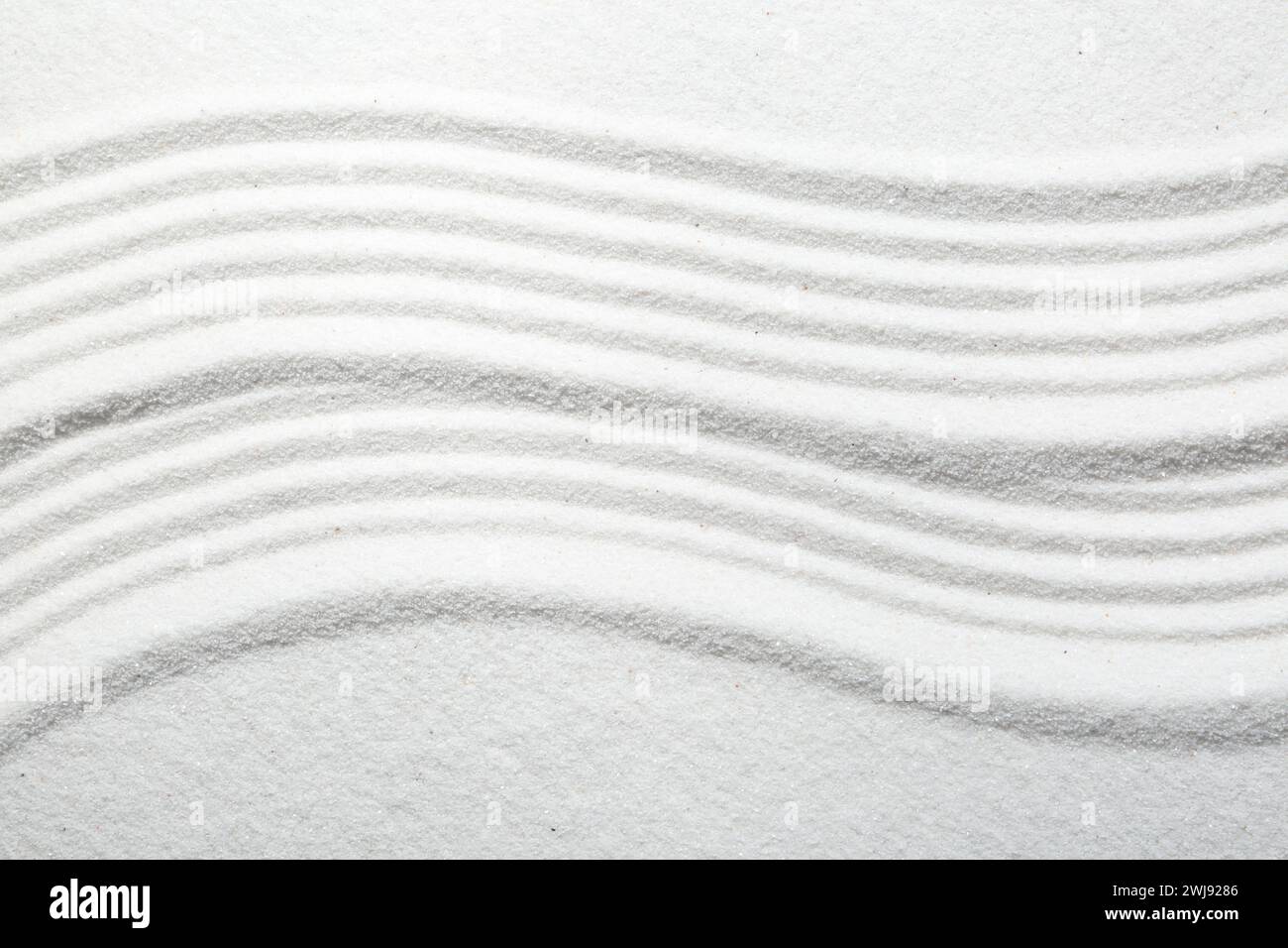 Zen rock garden. Wave pattern on white sand, top view Stock Photo - Alamy