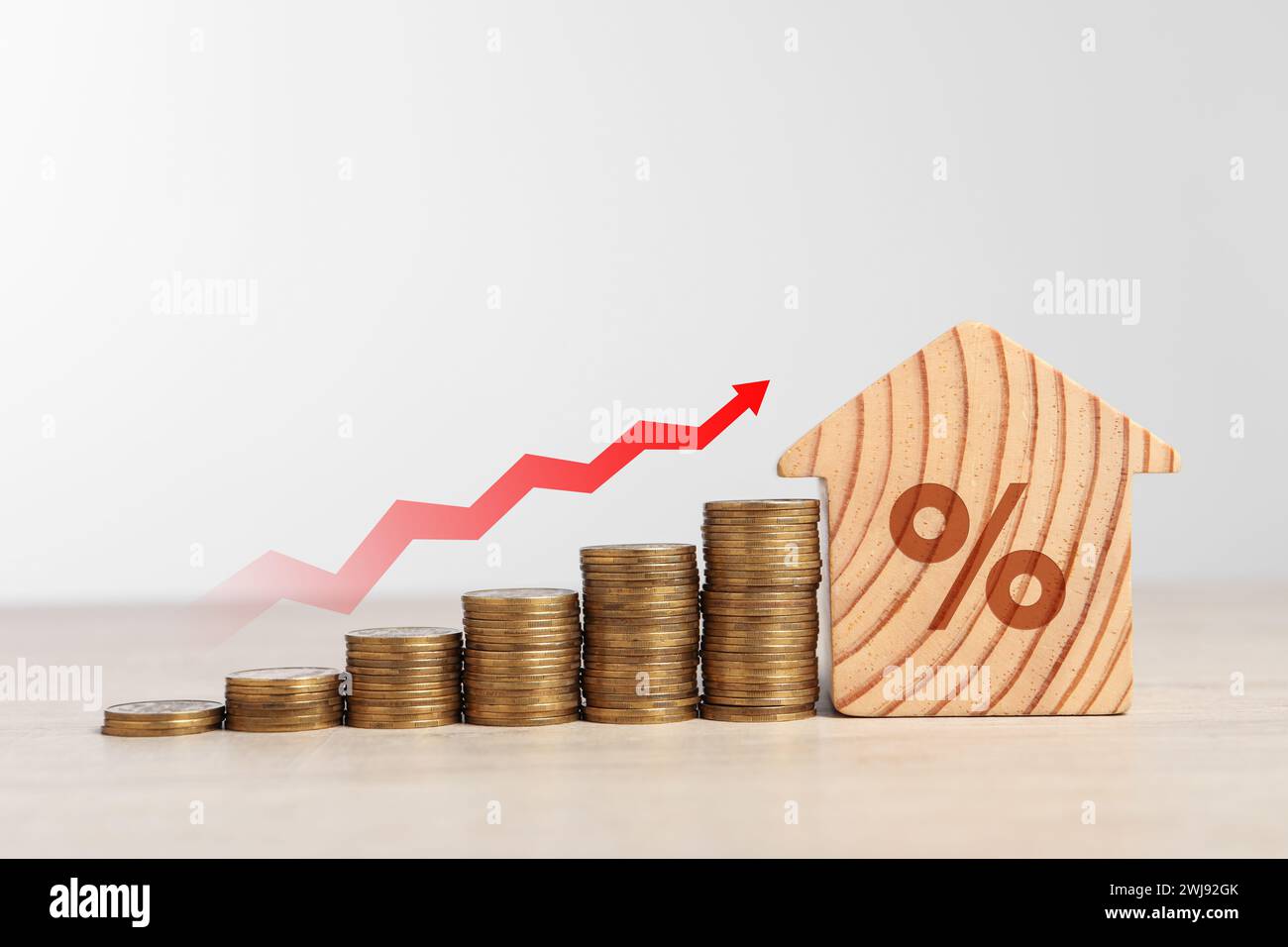 Mortgage rate. Stacked coins, arrow and wooden model of house with ...
