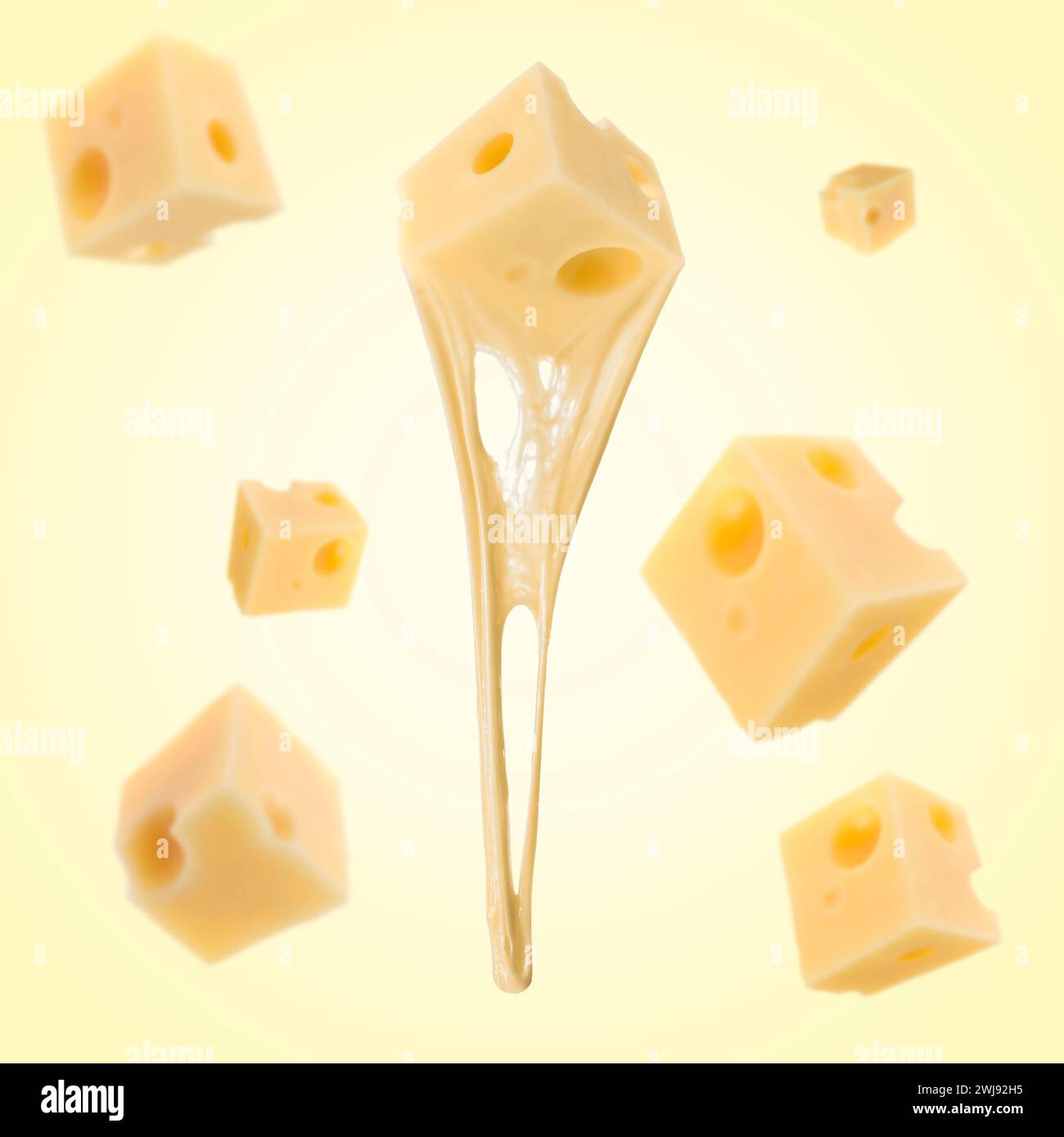Pieces of cheese falling on yellow background Stock Photo - Alamy