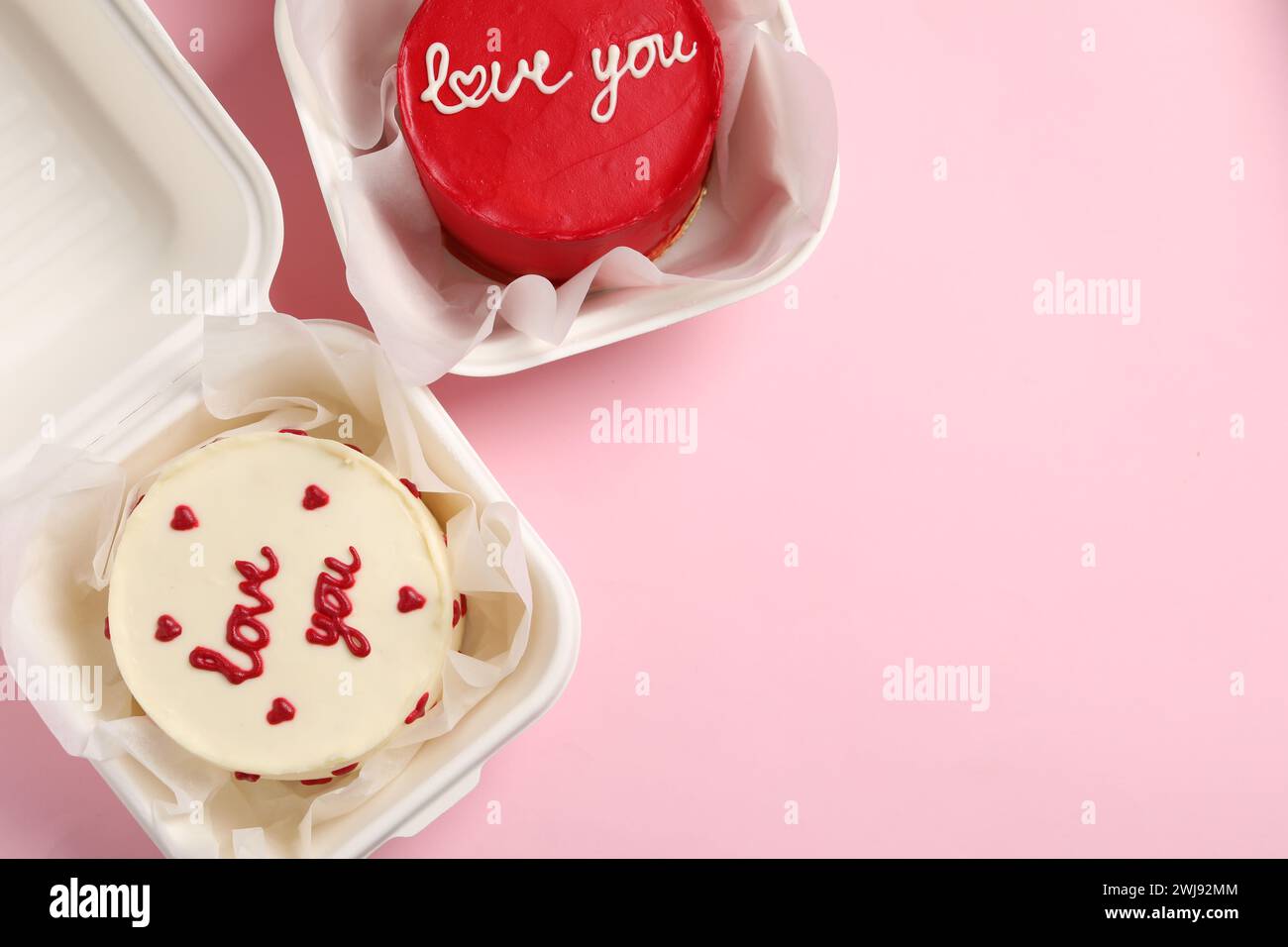 St. Valentine's day surprise. Bento cakes in takeaway boxes on pink ...