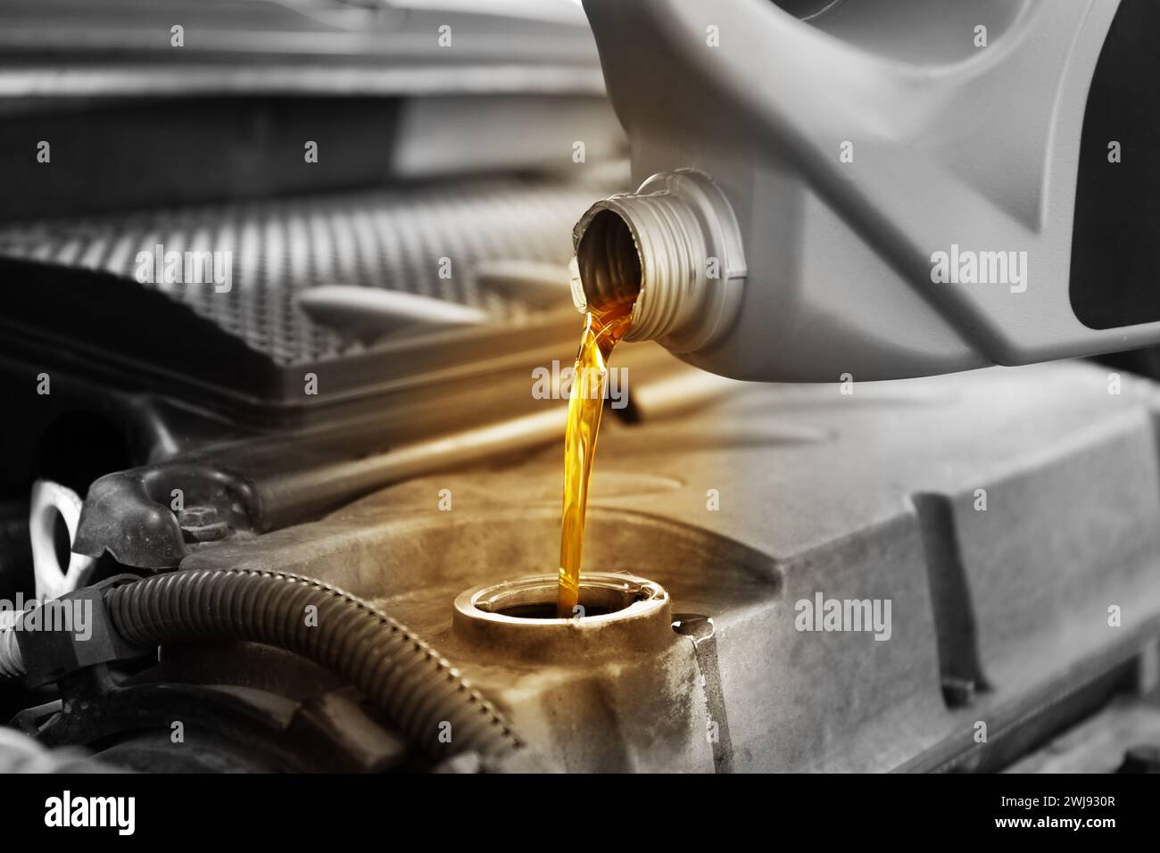 Pouring motor oil into car engine, closeup. Color accent effect Stock ...