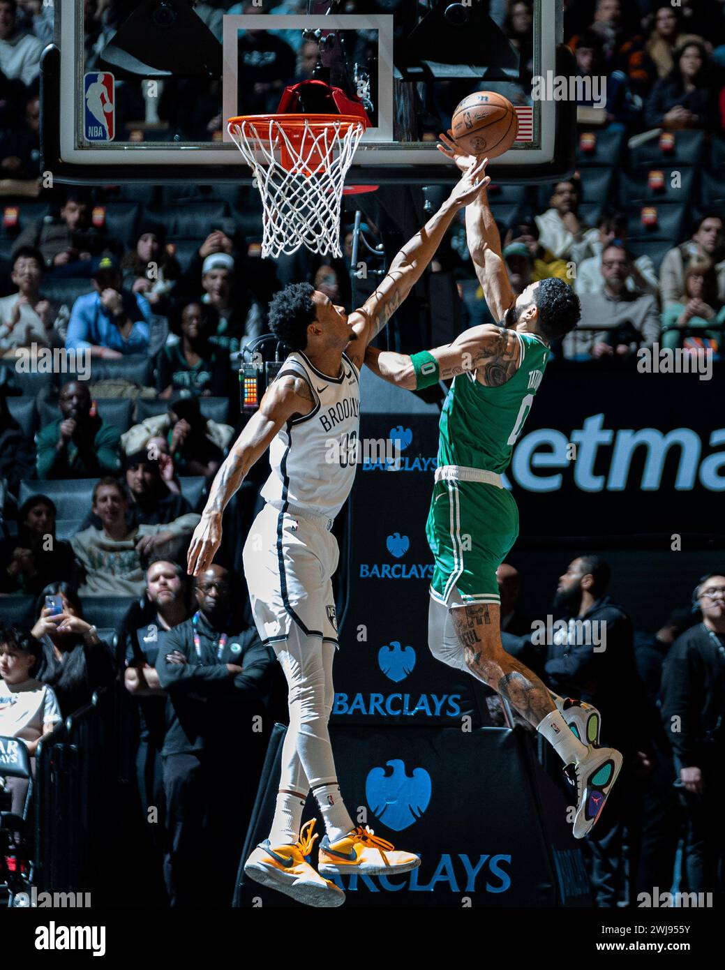 Boston Celtics forward Jayson Tatum, right, is defended by Brooklyn Nets center Nic Claxton (33 ...