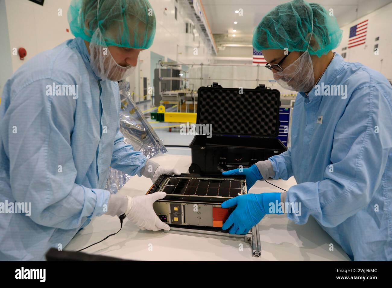 Engineers preparing LunaH-Map CubeSat before installation Stock Photo ...