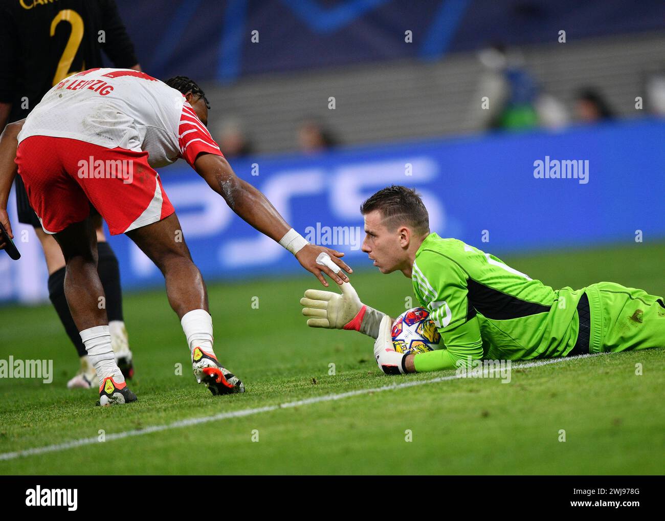 Leipzig, Germany. 13th Feb, 2024. Andriy Lunin (R), goalkeeper of Real ...