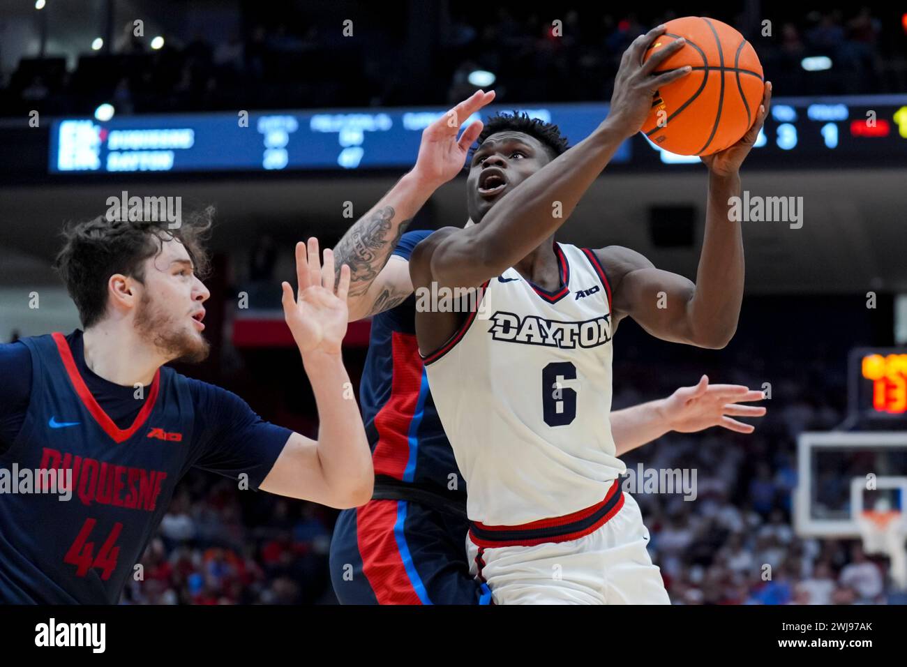 Dayton guard Enoch Cheeks (6) drives to the basket against Duquesne ...