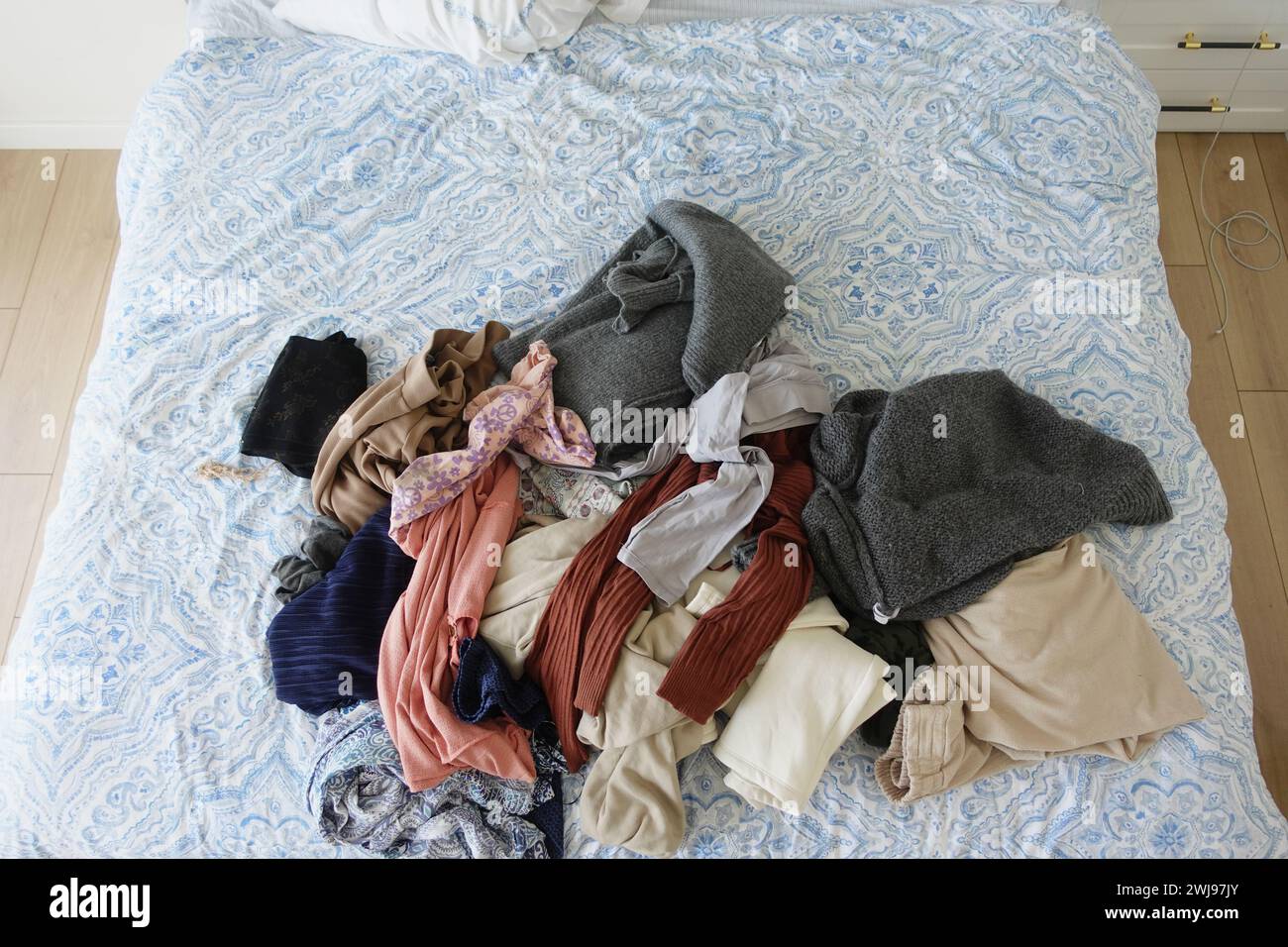 messy bed with cloths in early morning , messy bed after waking up ...