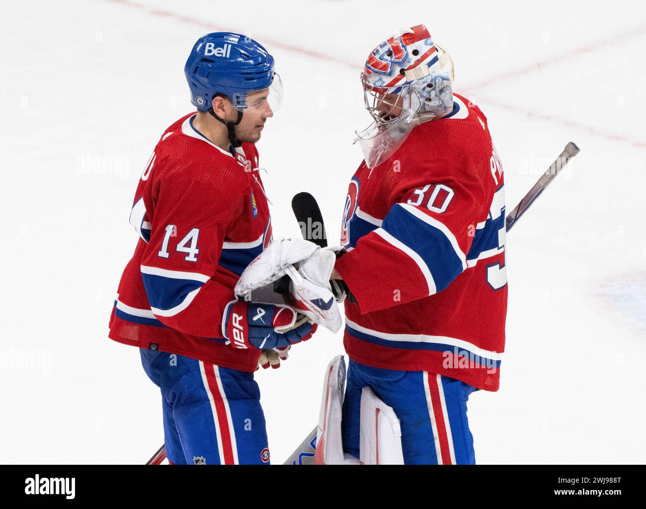 Montreal Canadiens goaltender Cayden Primeau (30) hands teammate Nick ...