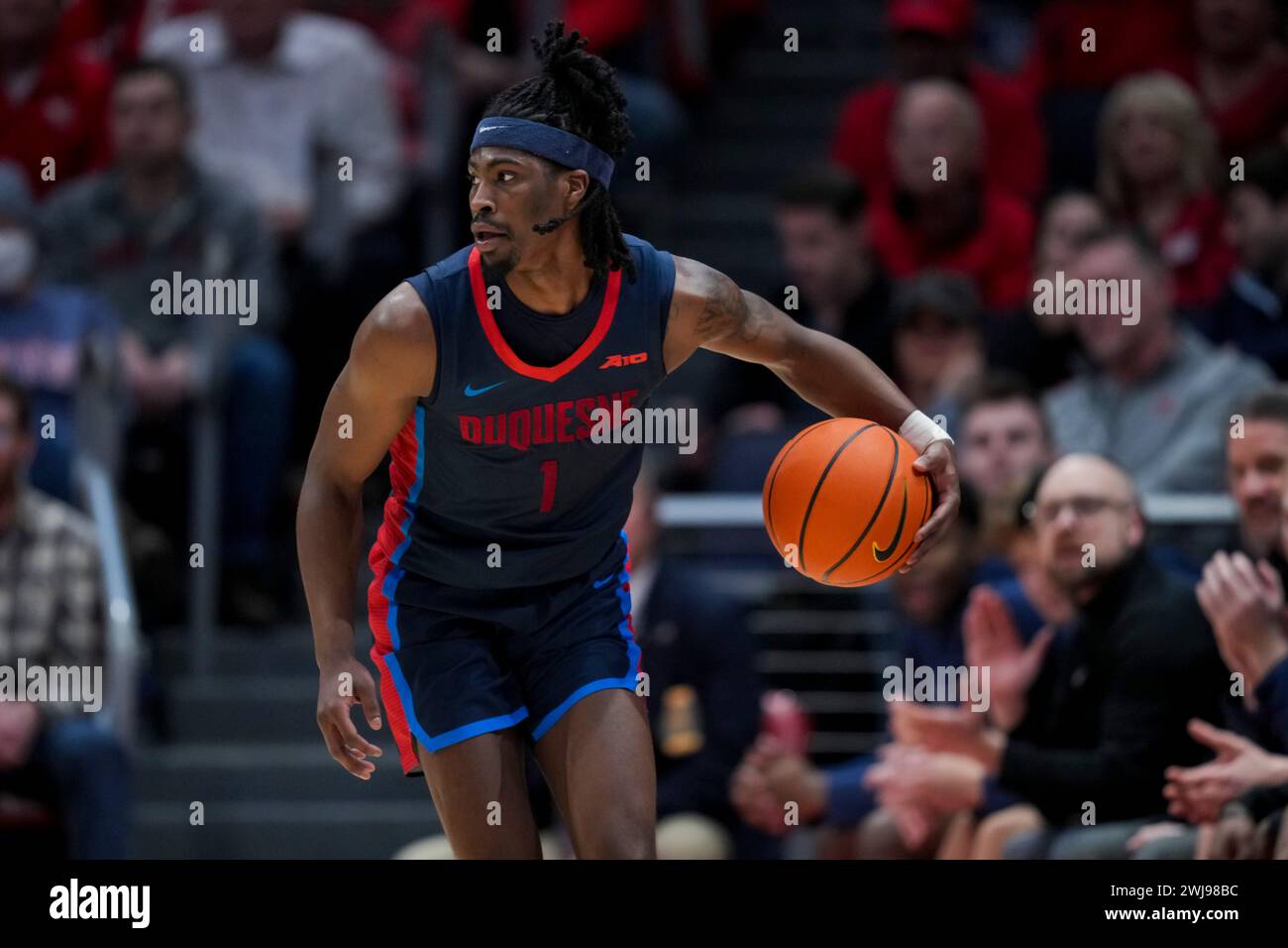 Duquesne guard Jimmy Clark III (1) dribbles the ball during an NCAA ...