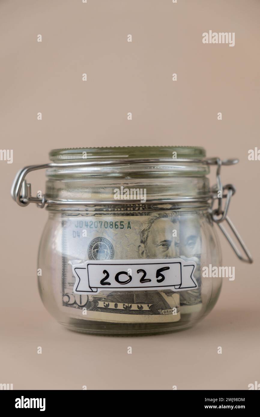 Glass jar full of American currency dollars cash banknote with text ...