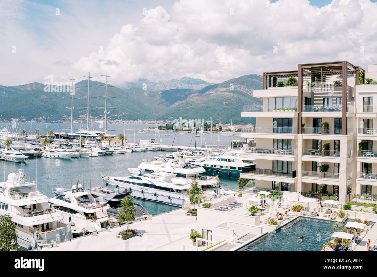 Yachts are moored offshore with the luxurious Regent Pool Club ...