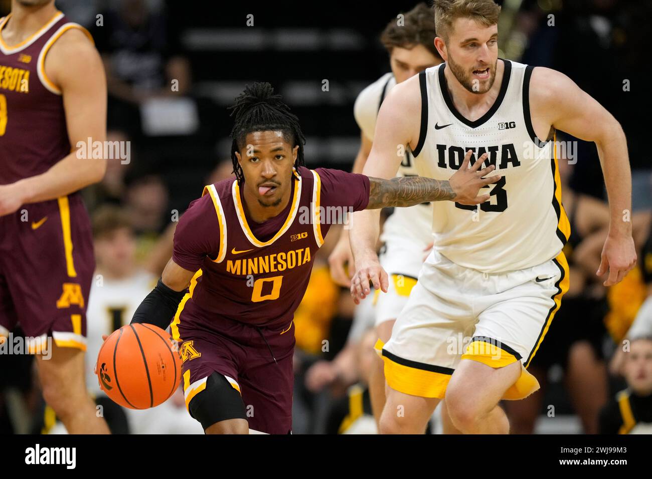 Minnesota guard Elijah Hawkins (0) drives up court ahead of Iowa ...