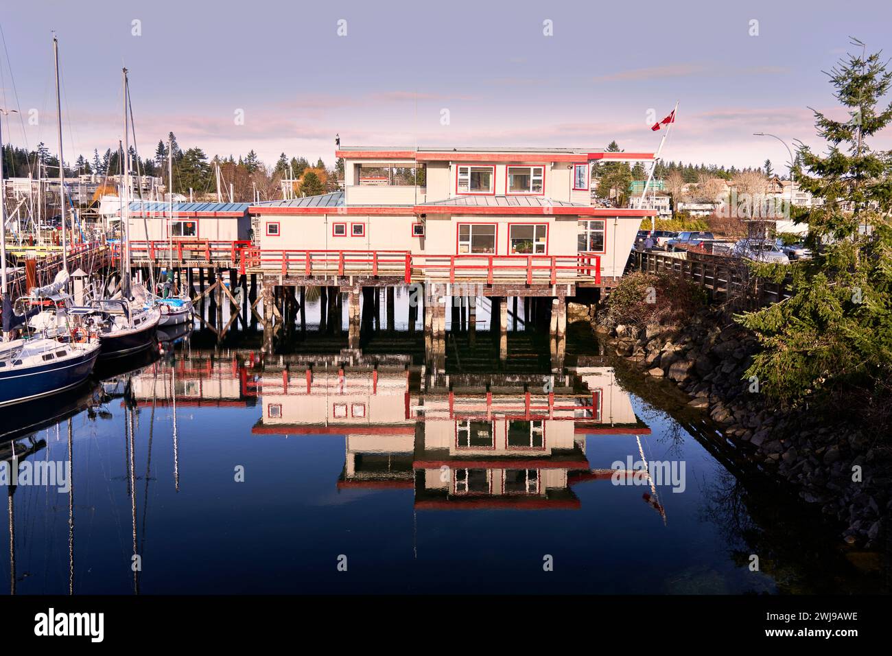 Comox Harbour ofice, a building on piles, and it's reflection in the ...