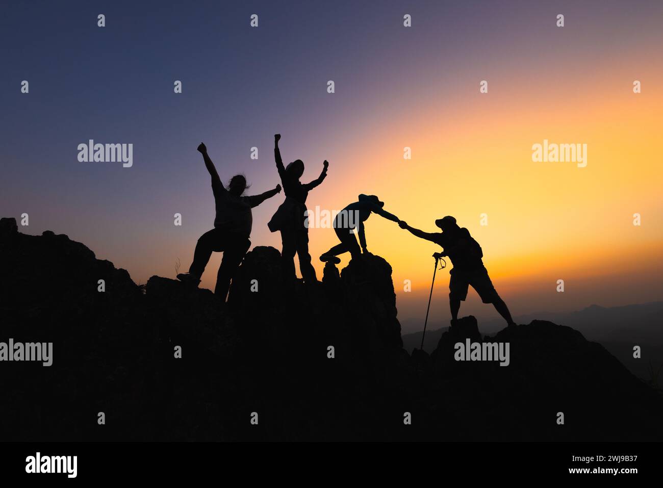 Silhouette Teamwork of four hiker helping each other on top of mountain ...
