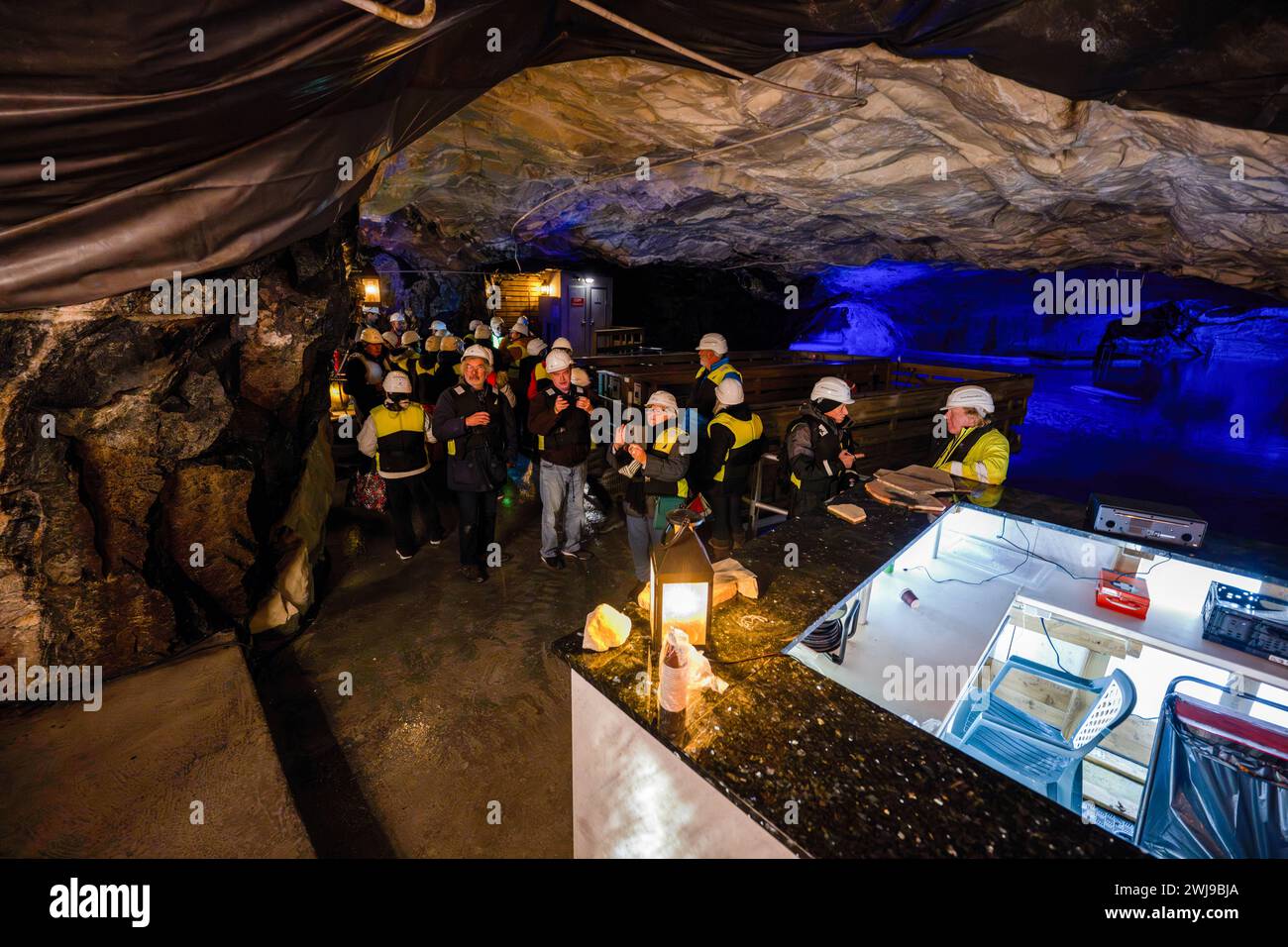 A miner explains to a visitor the properties of the rocks during a ...