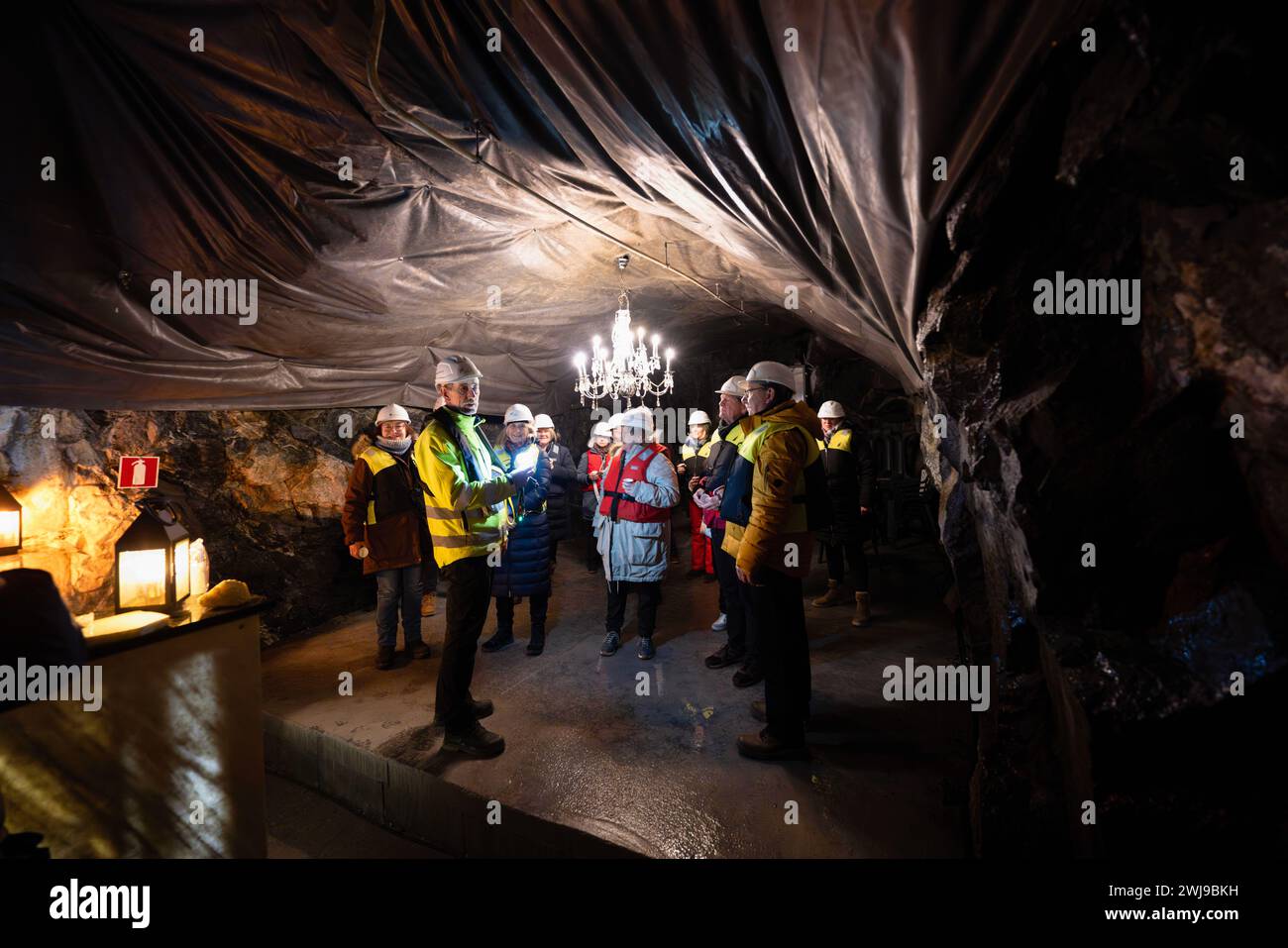 A miner explains to a visitor the properties of the rocks during a ...