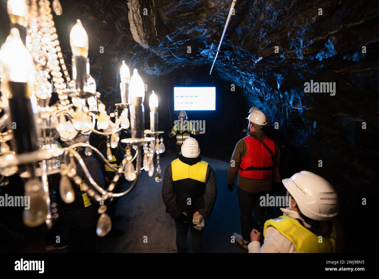 A miner explains to a visitor the properties of the rocks during a ...
