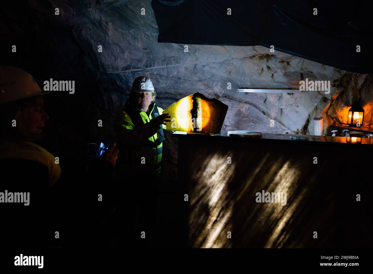 A miner explains to a visitor the properties of the rocks during a ...