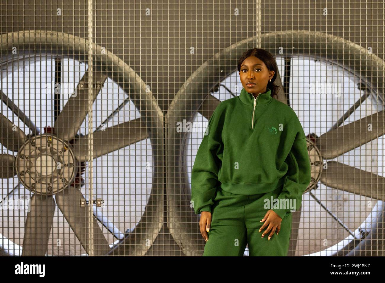 In this industrial setting, an African American woman stands ...