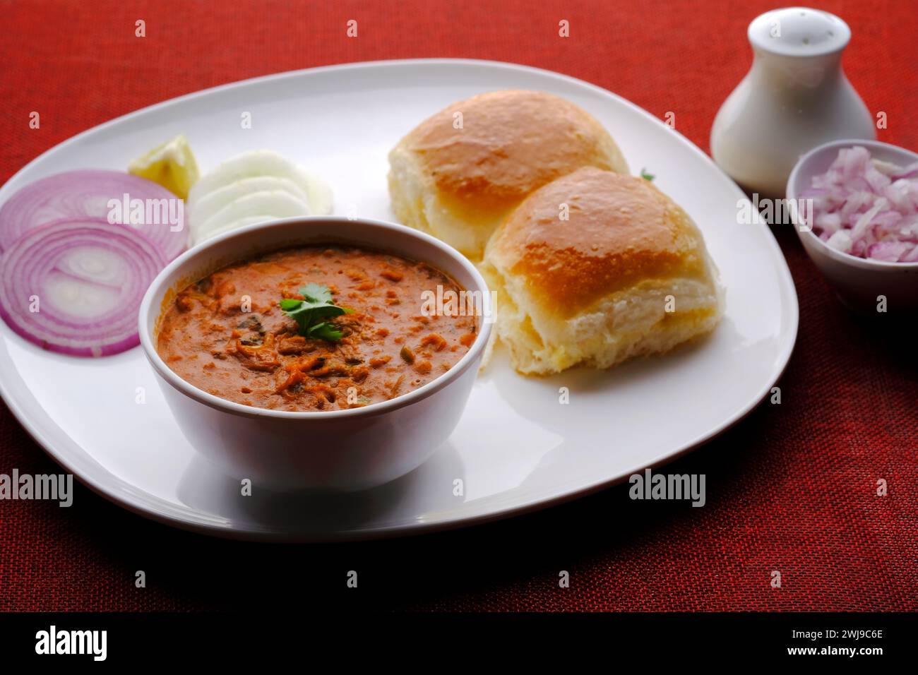 Pav Bhaji Indian spicy fast food with bread, onion and butter, Indian ...