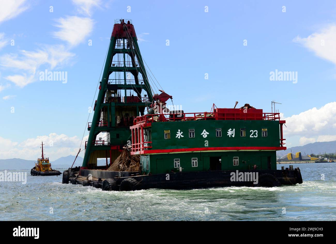 A Tugboat pulling a barge in Victoria Harbour in Hong Kong Stock Photo ...