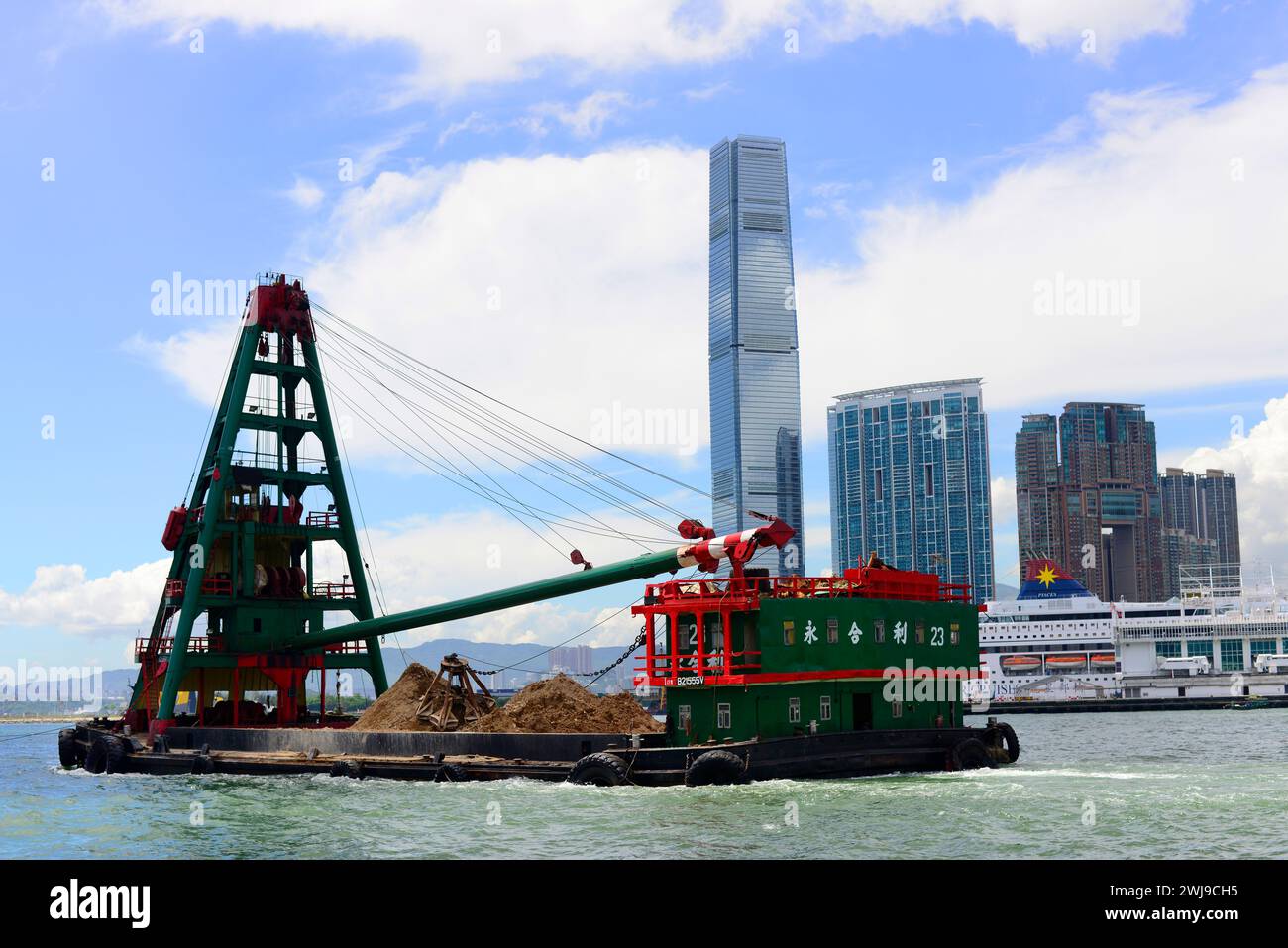 A Tugboat pulling a barge in Victoria Harbour in Hong Kong Stock Photo ...
