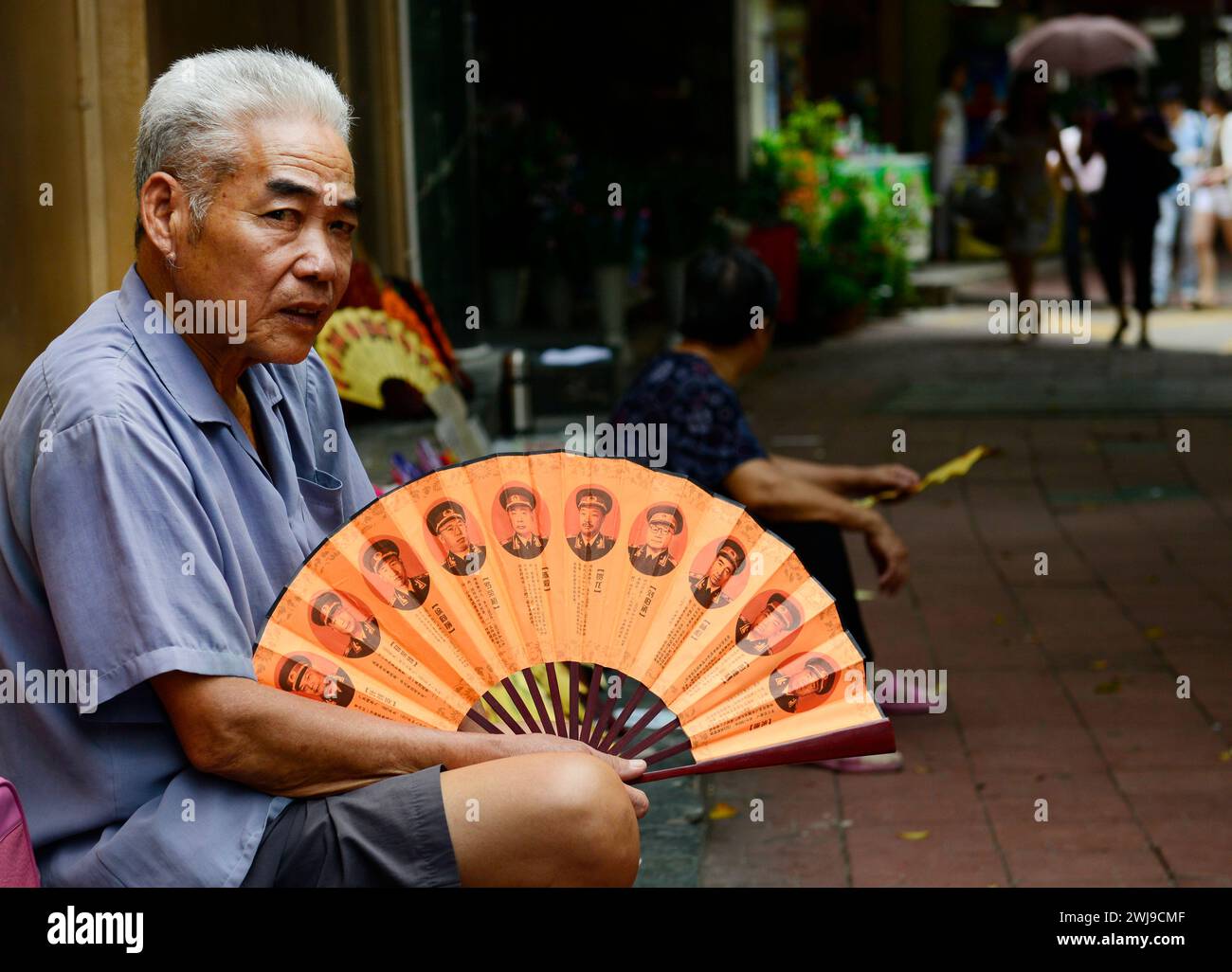 A man selling traditional Chinese paper fans in Shenzhen, China Stock ...