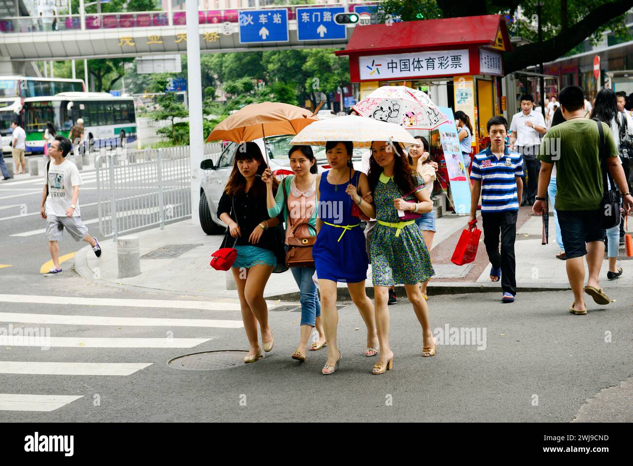 A group of young modern Chinese women with their umbrellas in Shenzhen ...