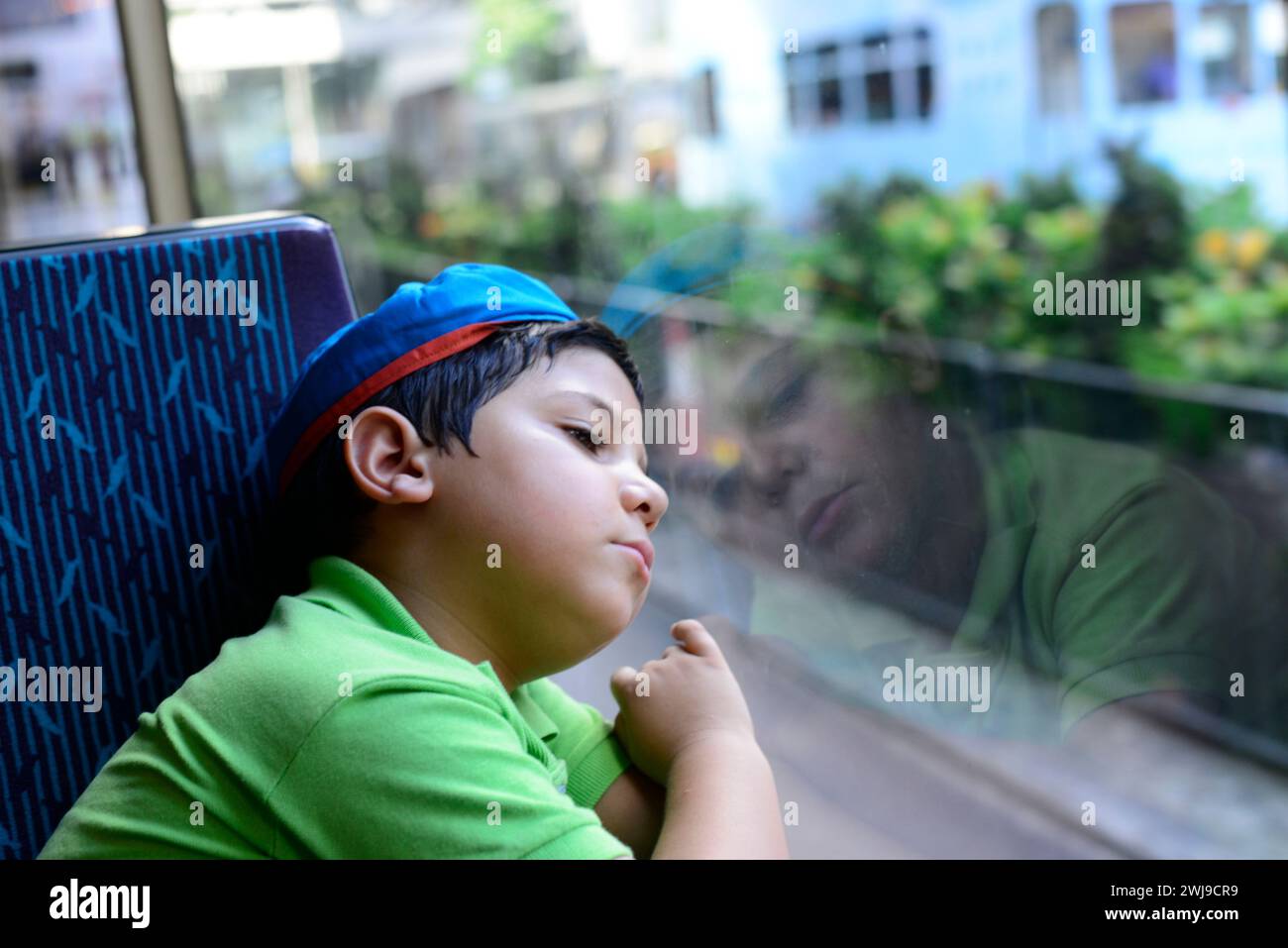 A young boy gazing out the bus window Stock Photo - Alamy