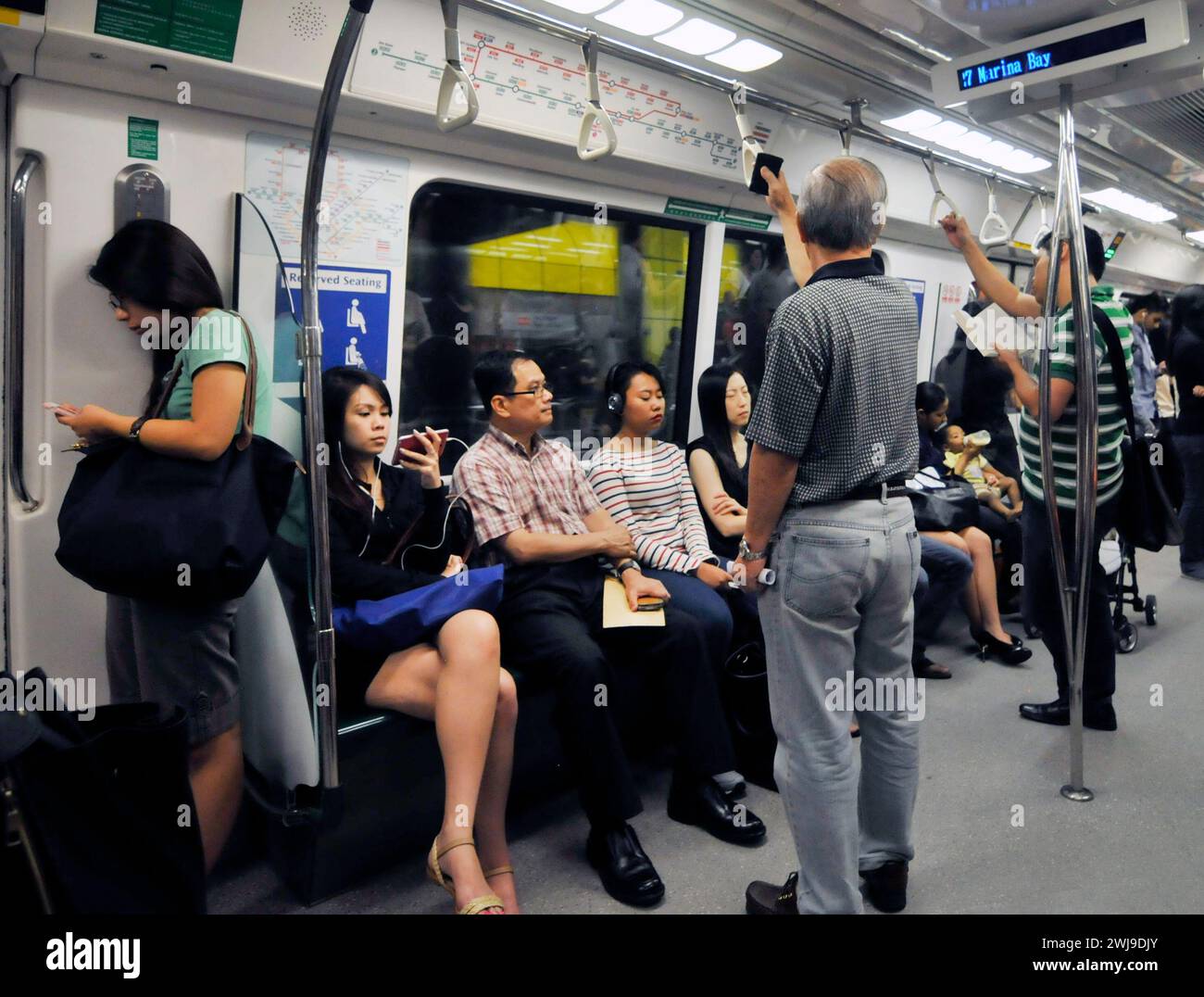 Singaporeans riding the MRT in Singapore Stock Photo - Alamy